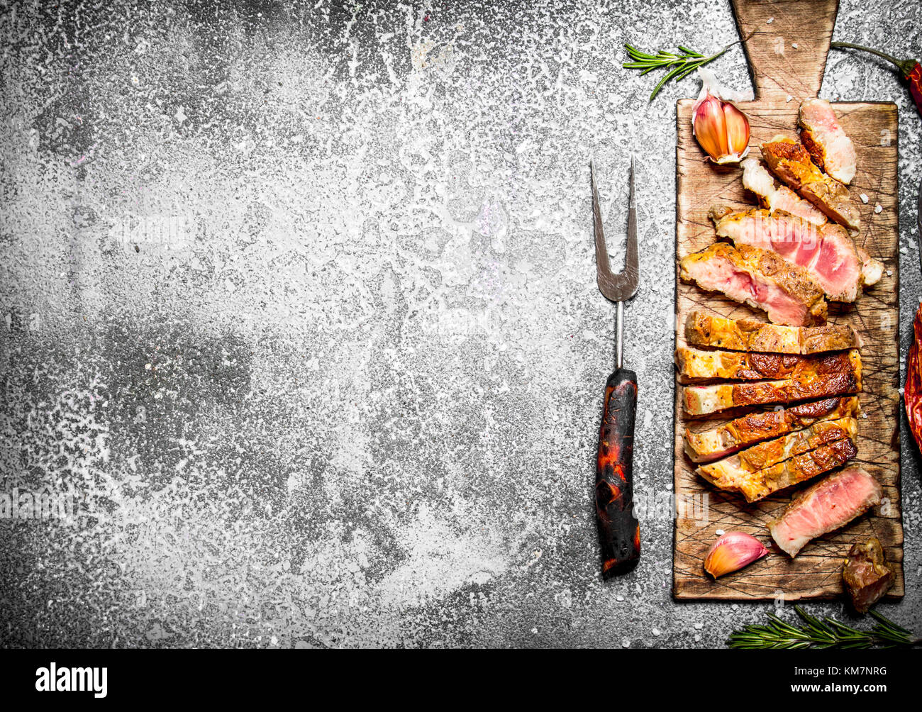 Meat grill. Cut a steak of roasted meat with spices. On rustic ...