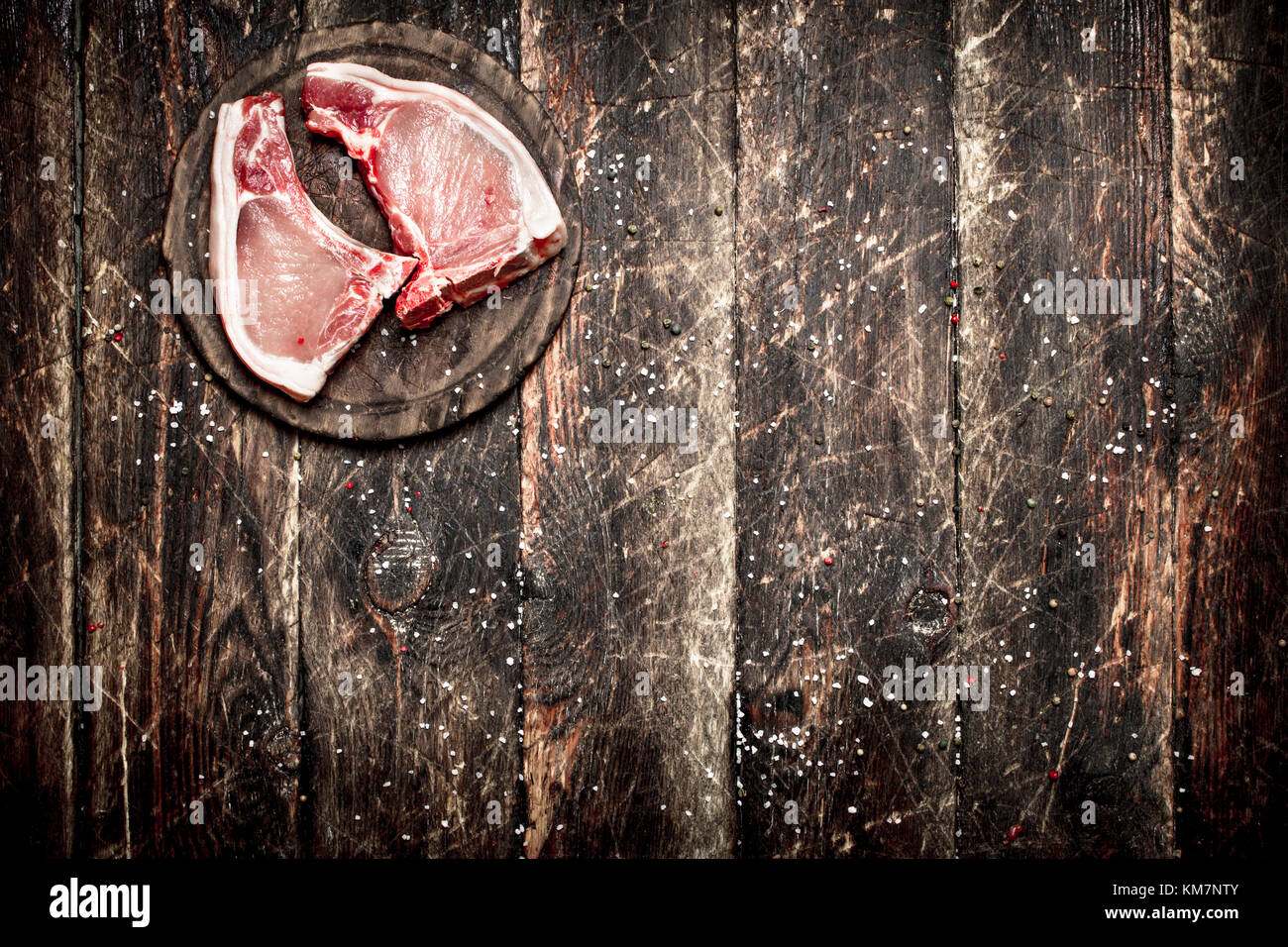 Raw meat background. A piece of raw pork on the old Board. On wooden ...