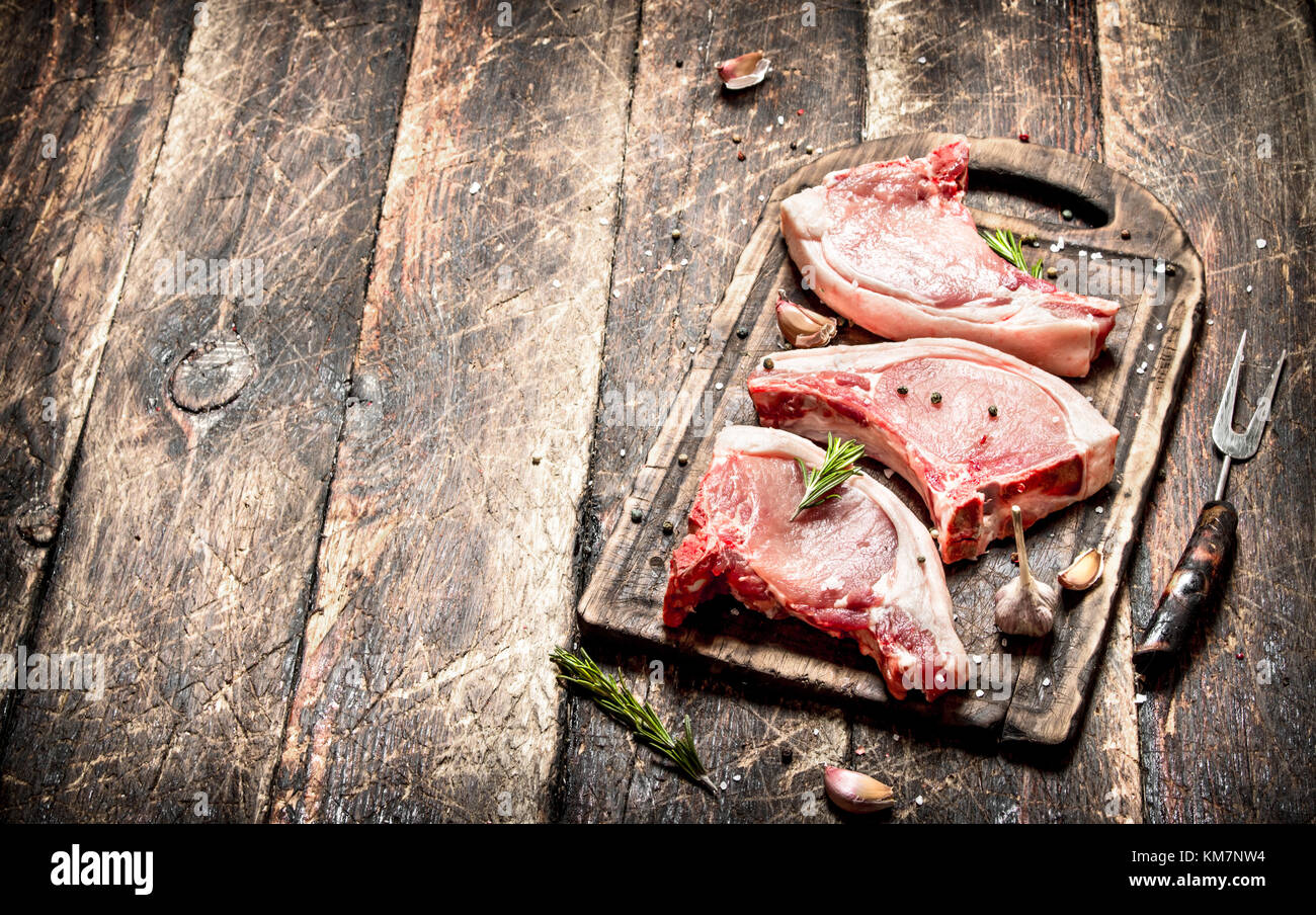 Raw meat background. Raw pork with spices . On the old wooden table ...