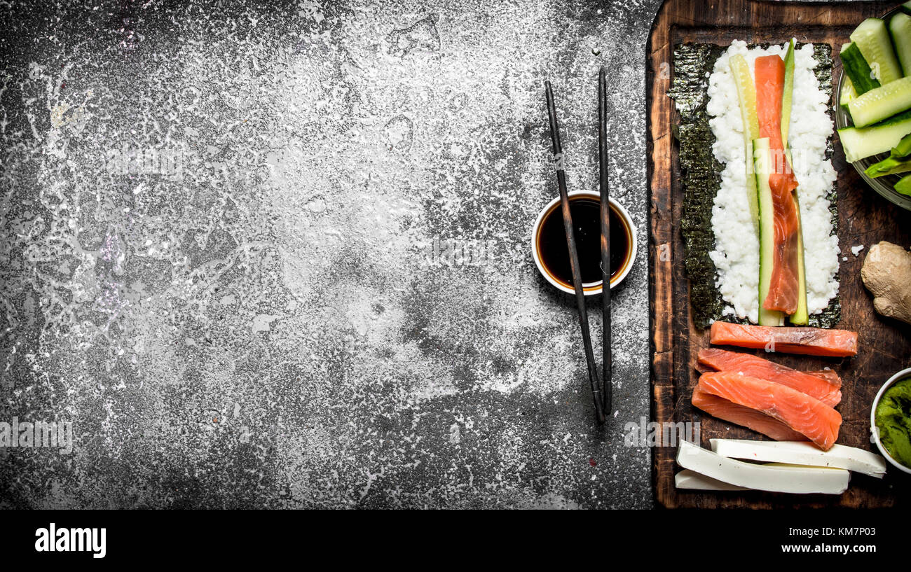 Japanese food. Cooking traditional rolls with fresh seafood. On rustic ...