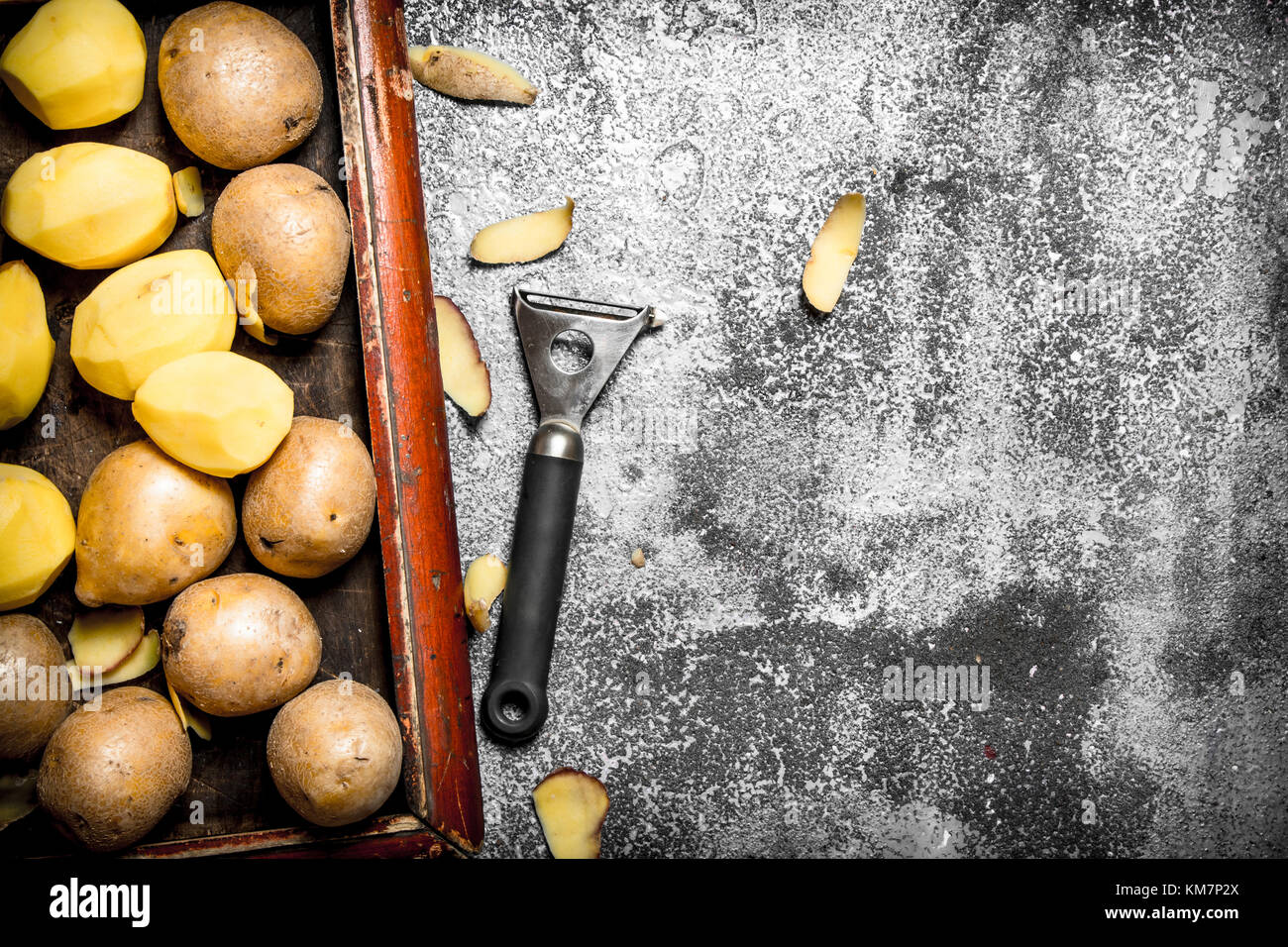 Fresh potatoes in an old tray. On rustic background Stock Photo - Alamy
