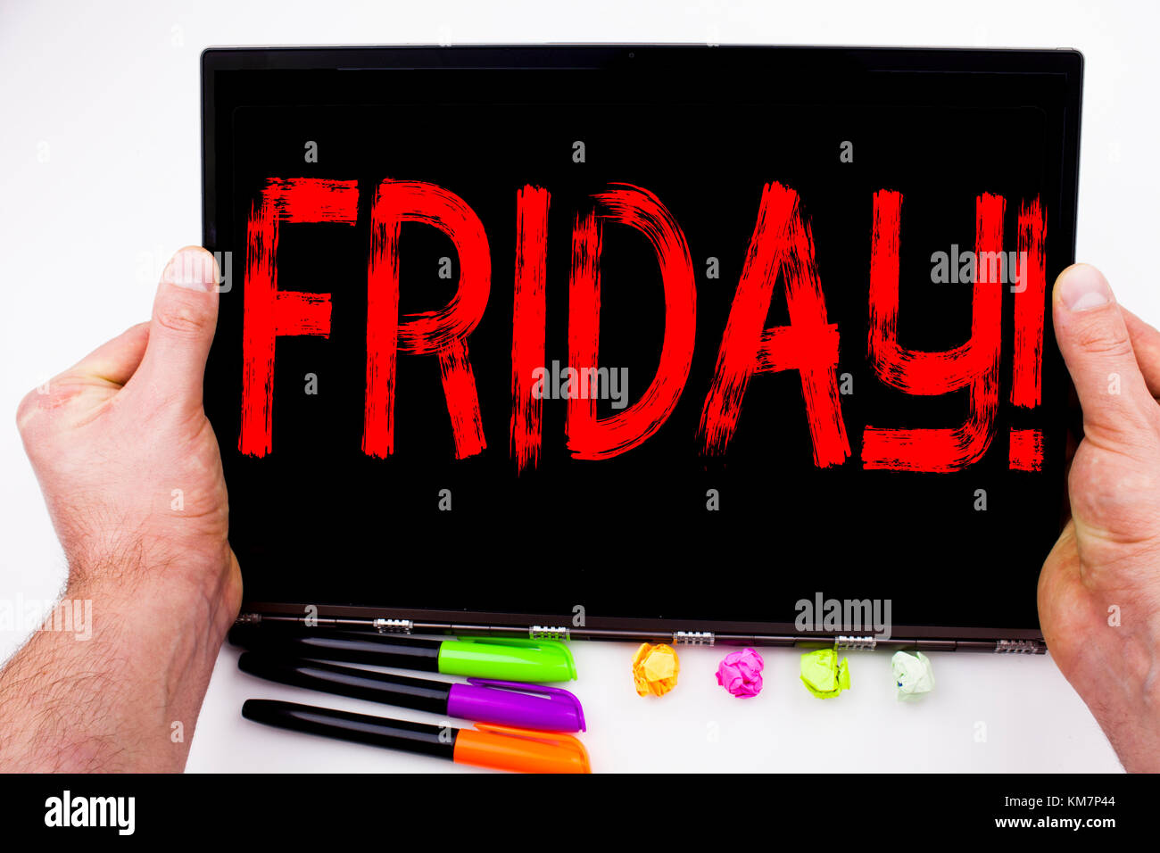 Friday text written on tablet, computer in the office with marker, pen ...