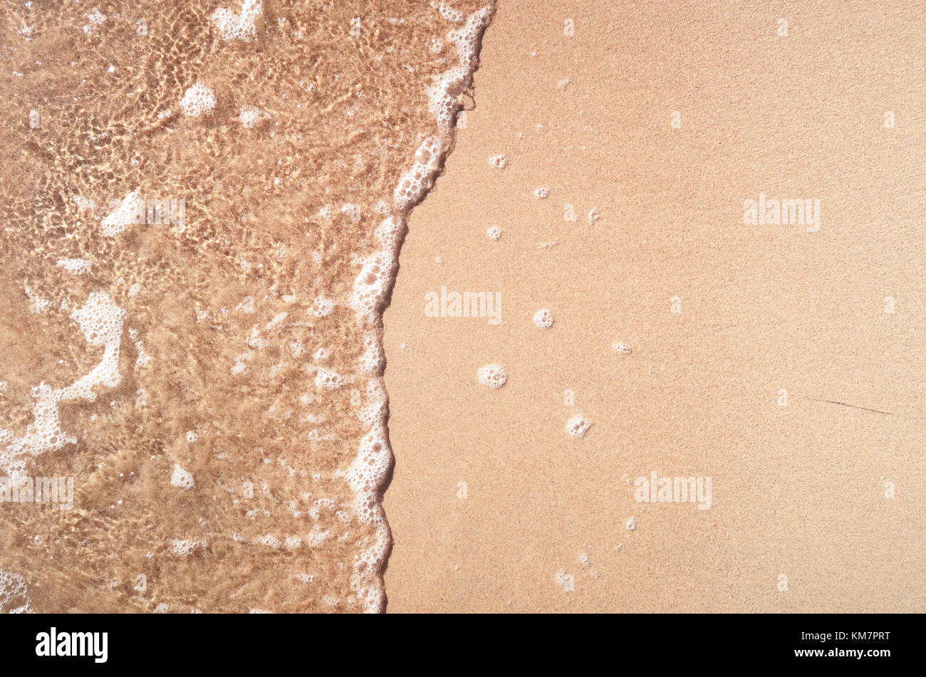 Transparent soft wave on sandy beach Stock Photo - Alamy