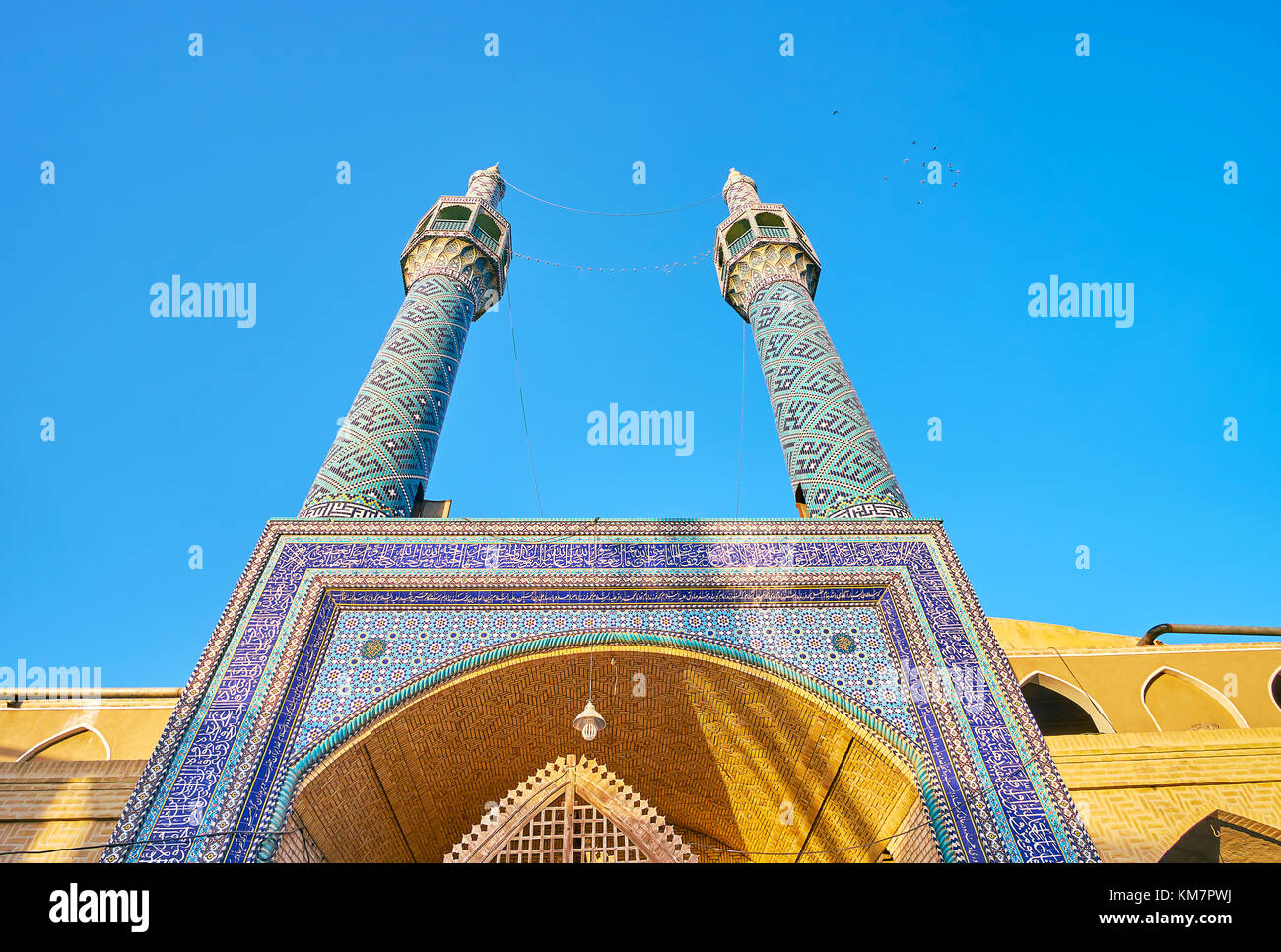 Tall minarets of Shahzade Fazl Holy Shrine decorated with tiles with ...