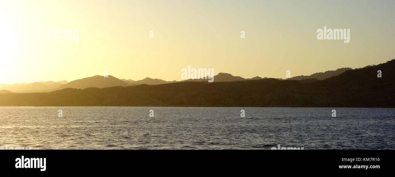 sunset over mountains Stock Photo - Alamy