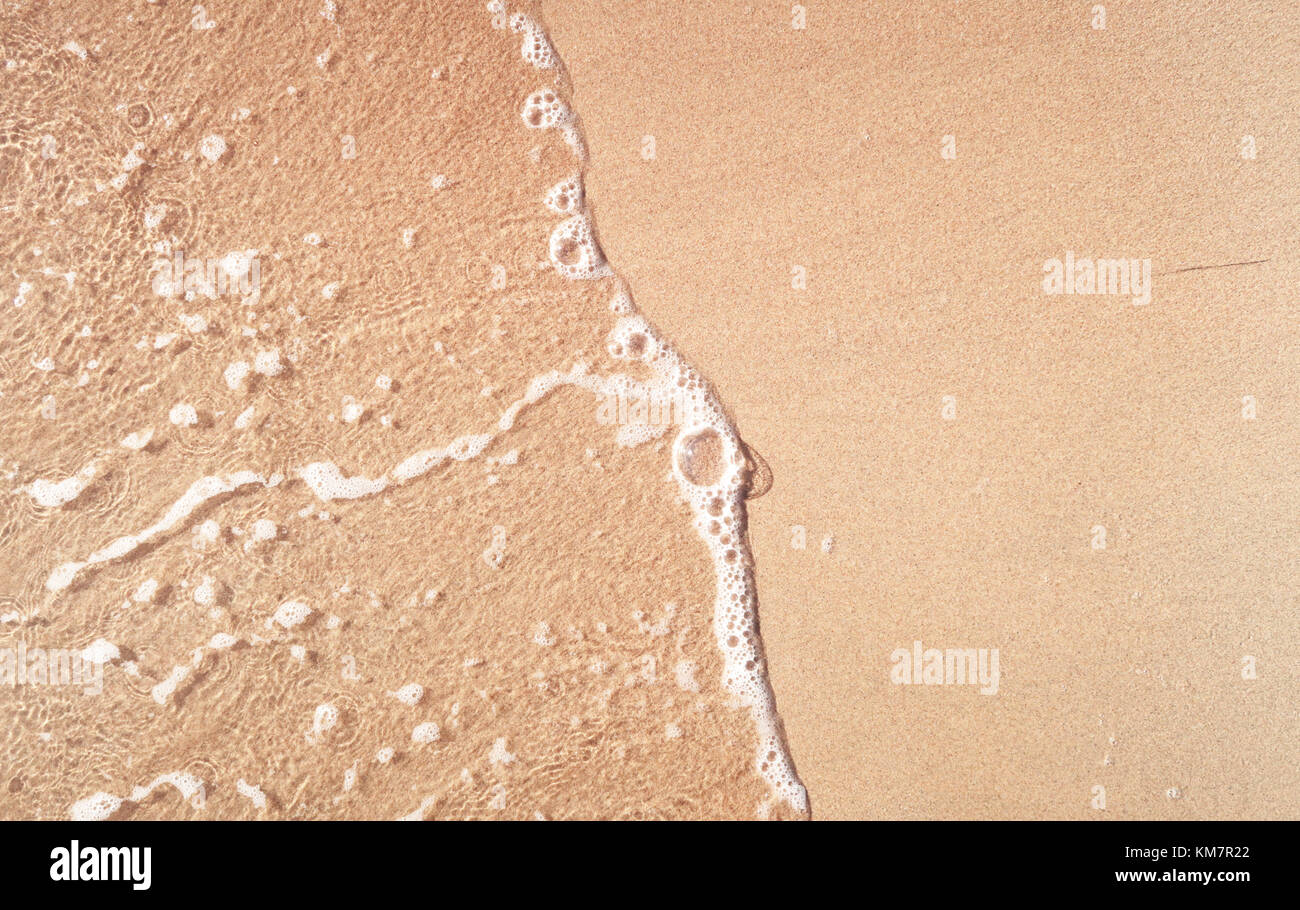 Transparent soft wave on sandy beach Stock Photo - Alamy