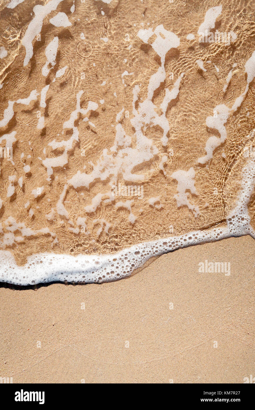 Transparent soft wave on sandy beach Stock Photo - Alamy