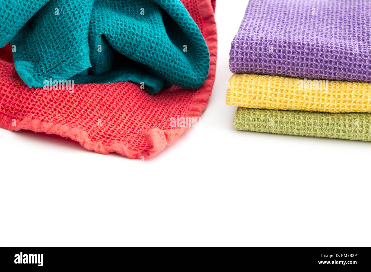 Pile of messy and stack of folded colorful kitchen towels, on white ...