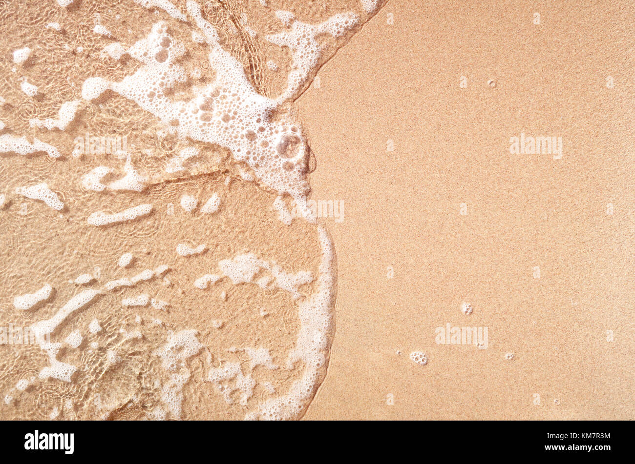 Transparent soft wave on sandy beach Stock Photo - Alamy