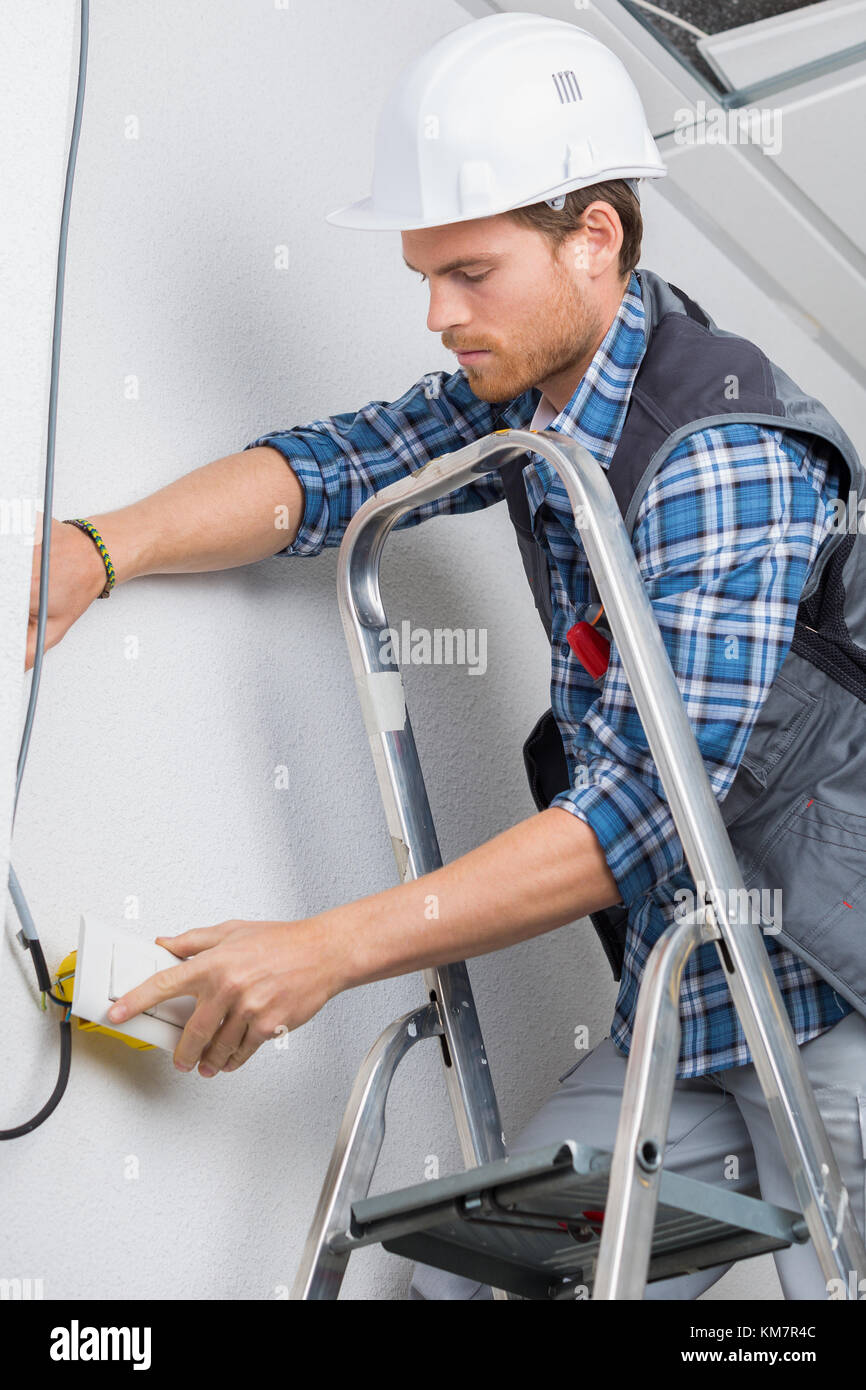 electrical worker wiring in ceiling Stock Photo - Alamy