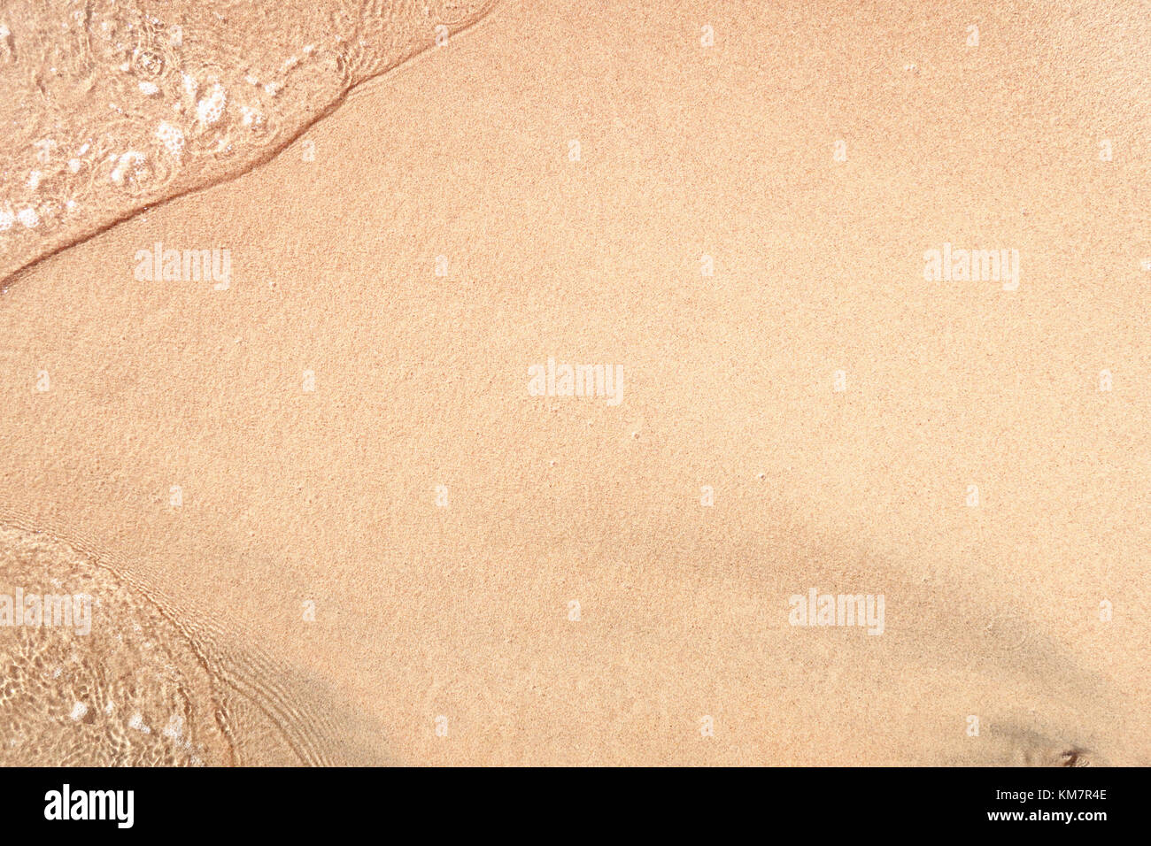 Transparent soft wave on sandy beach Stock Photo - Alamy