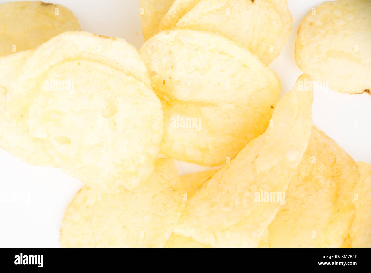 Crispy thinly sliced potato chips closeup, on white background Stock ...