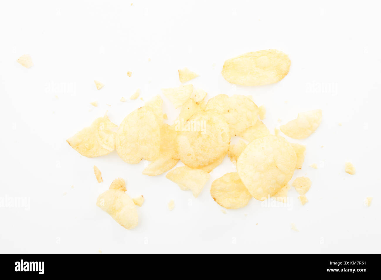 Crispy potato chips and crumbs, on white background Stock Photo - Alamy