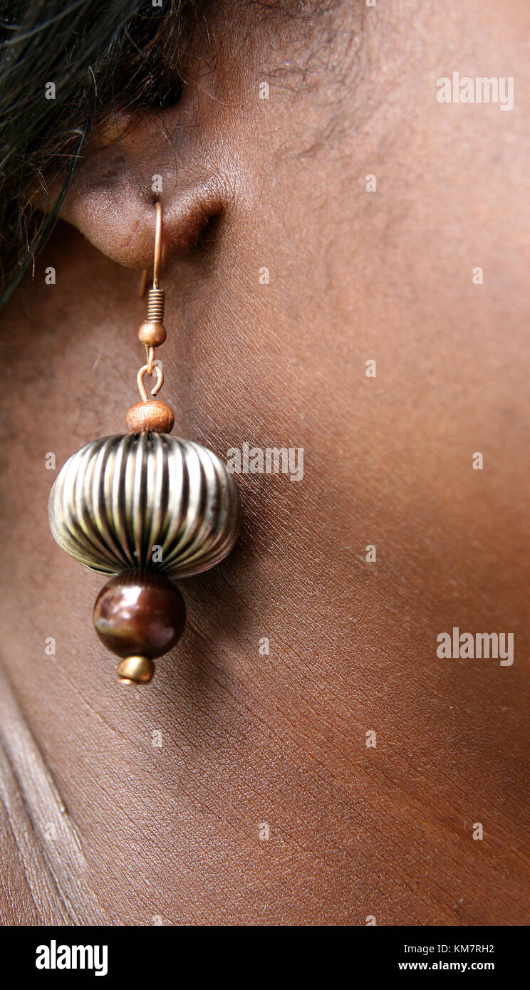 African woman's ear with earring Stock Photo - Alamy