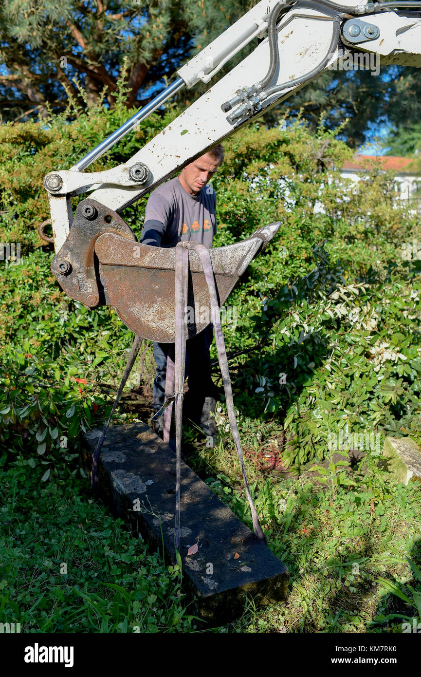 Using a digger in a garden Stock Photo - Alamy