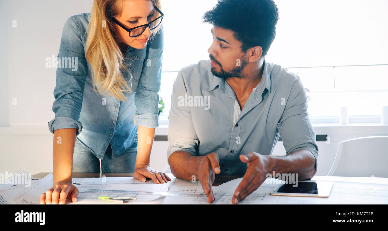 Portrait of architects having discussion in office Stock Photo - Alamy