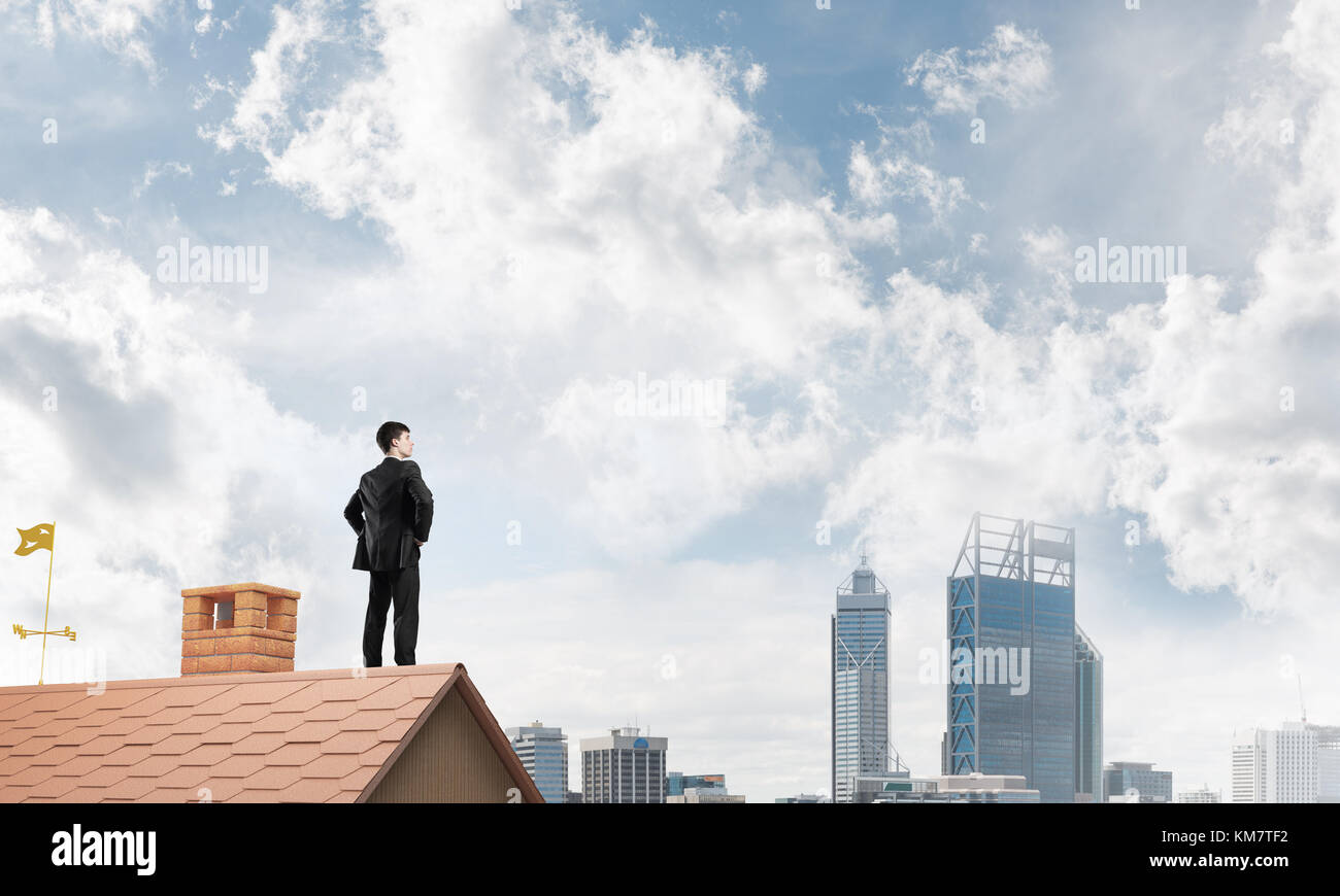 Mister boss on brick roof with arms akimbo. Mixed media Stock Photo - Alamy