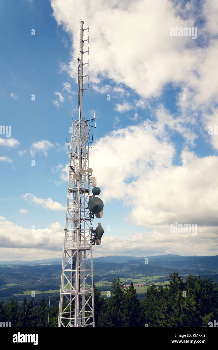 Aerials and transmitters on telecommunication tower with mountains in background Stock Photo - Alamy