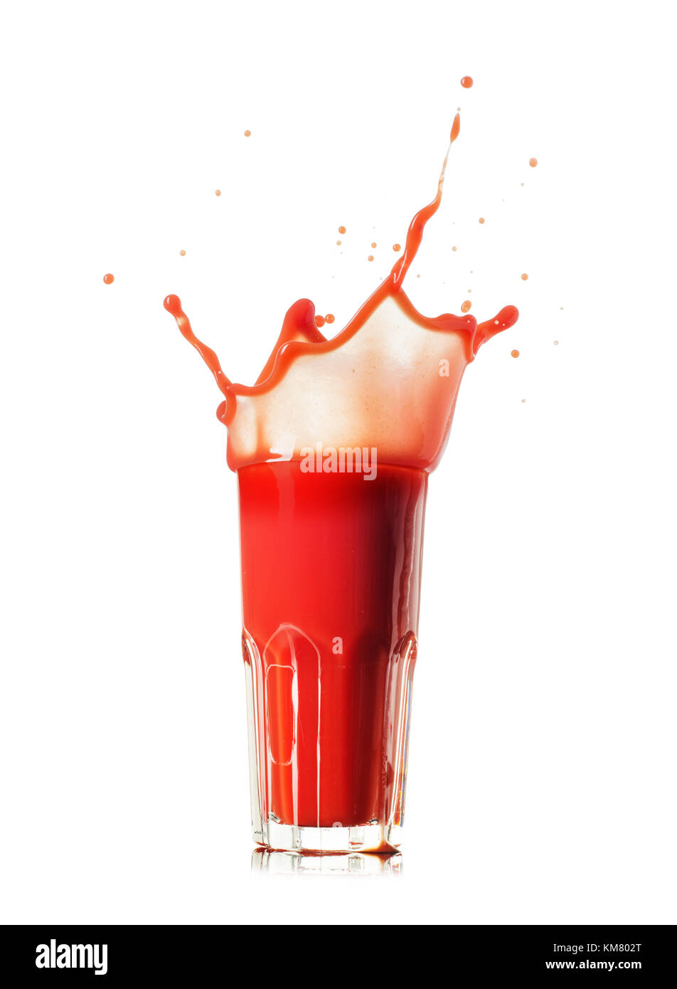 Tomato juice splash making amazing waves and dropsisolated on white ...