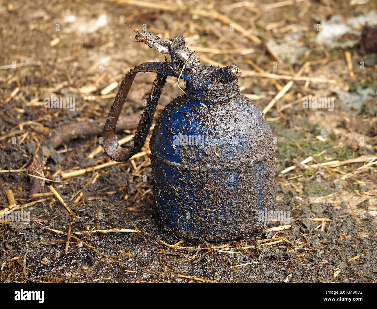 thick black oil congealed on a barely recognisable blue oil can left ...