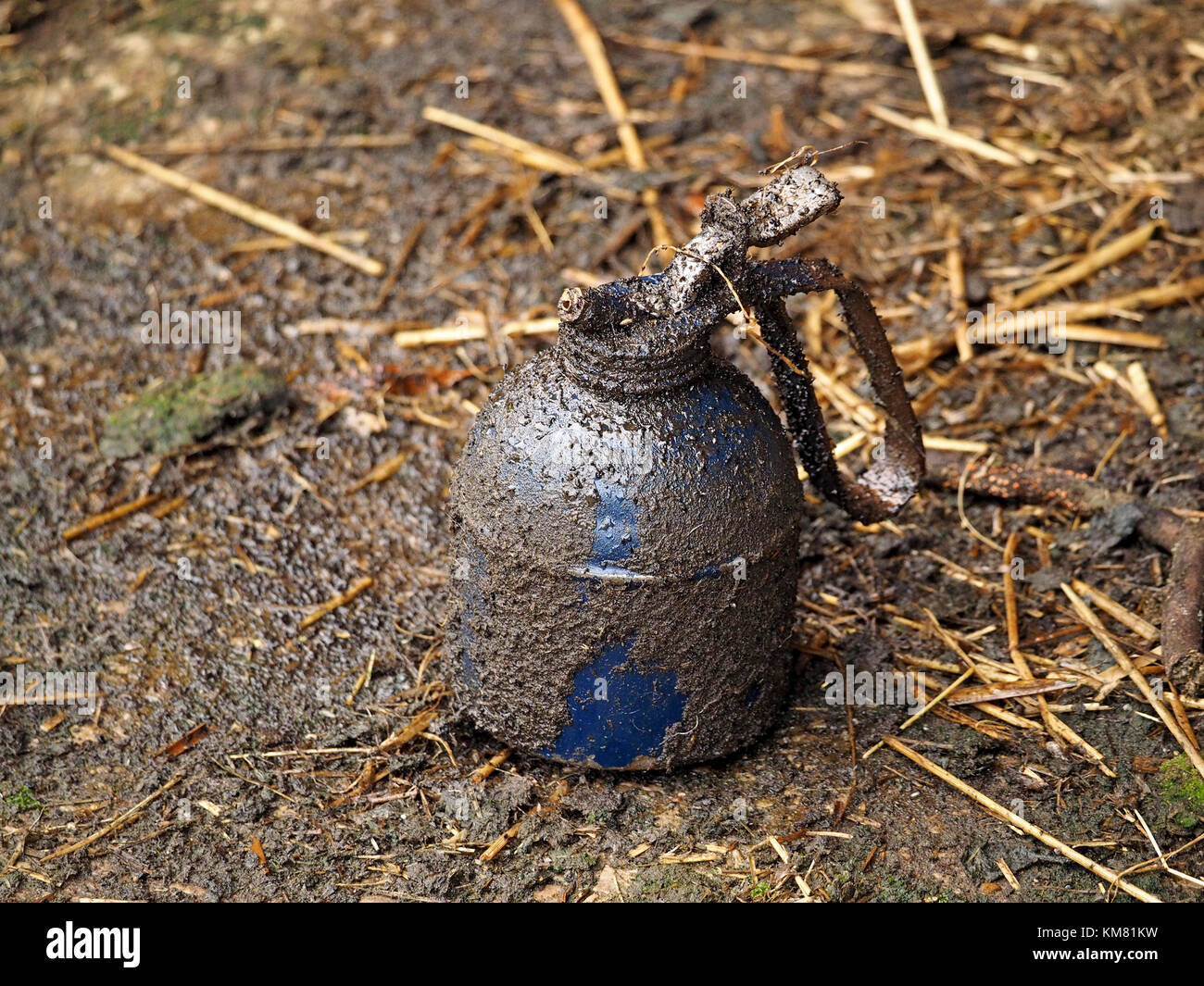 thick black oil congealed on a barely recognisable blue oil can left ...