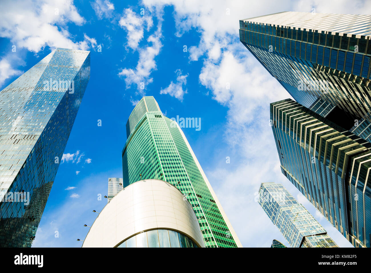 Skyscraper glass facades on a bright sunny day with sunbeams in the ...