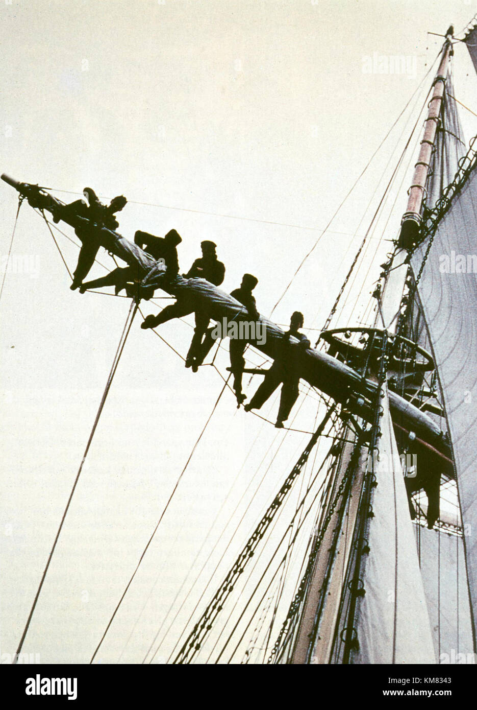 The photograph captures sailors working in a yard, likely at a naval ...