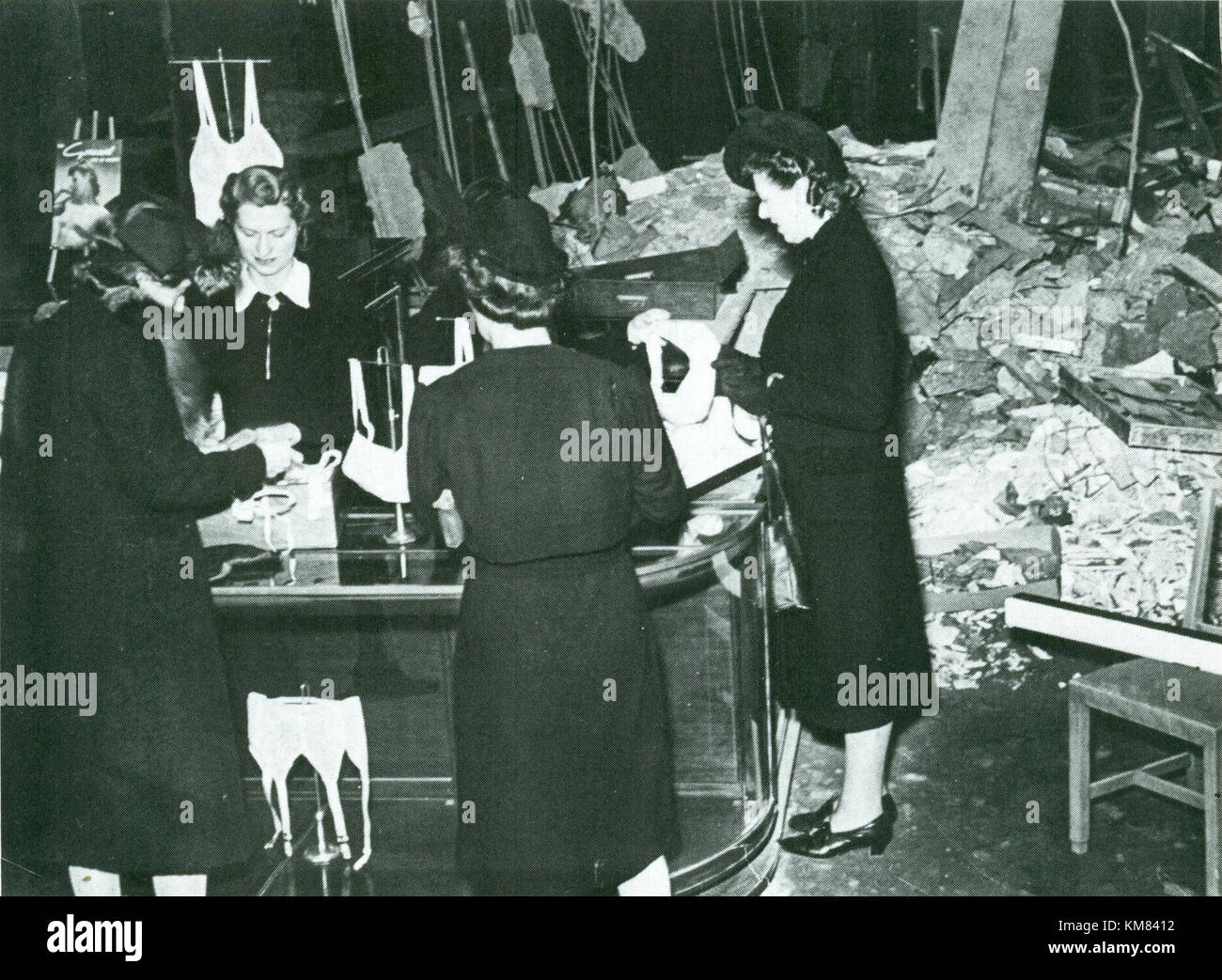 This photograph shows a London shop in the aftermath of a V1 bombing ...
