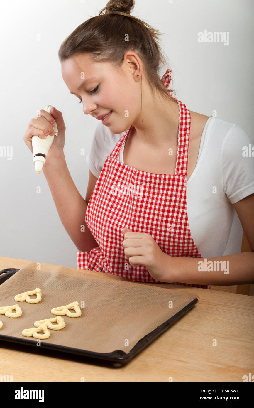 Woman making heart shaped cookies Stock Photo - Alamy
