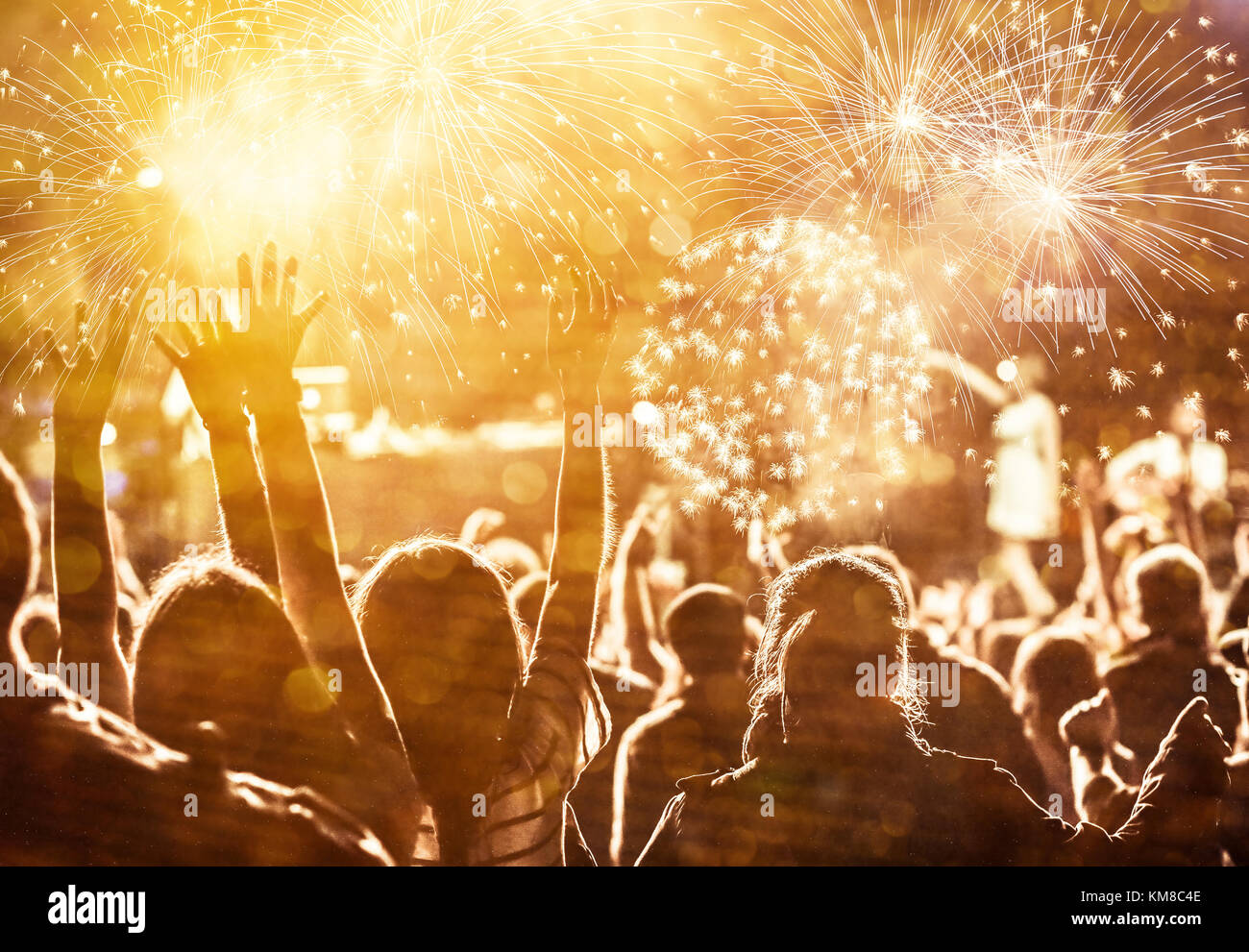 cheering crowd watching fireworks at New Year - holiday celebration ...