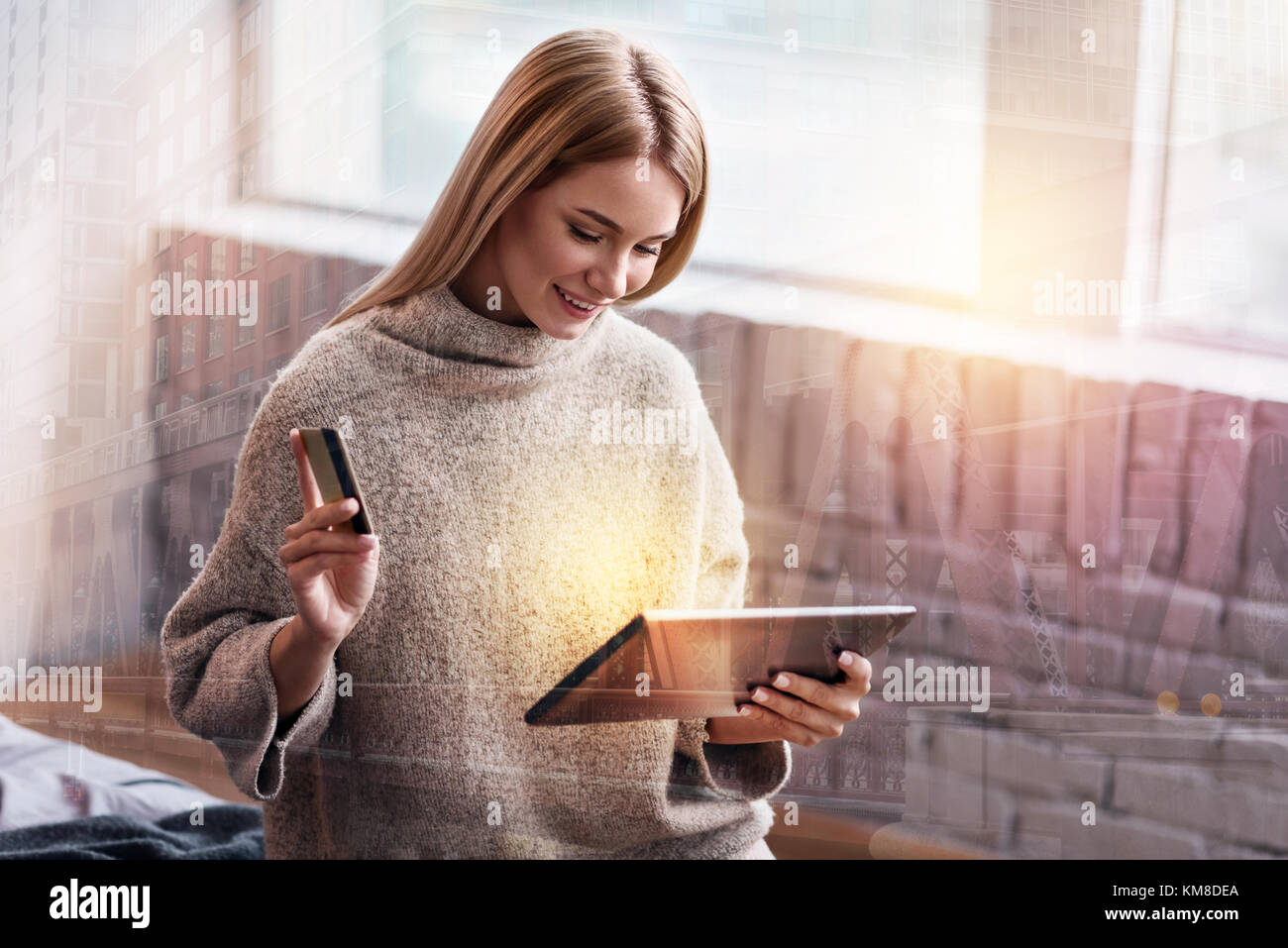 Happy nice woman looking at the tablet screen Stock Photo - Alamy