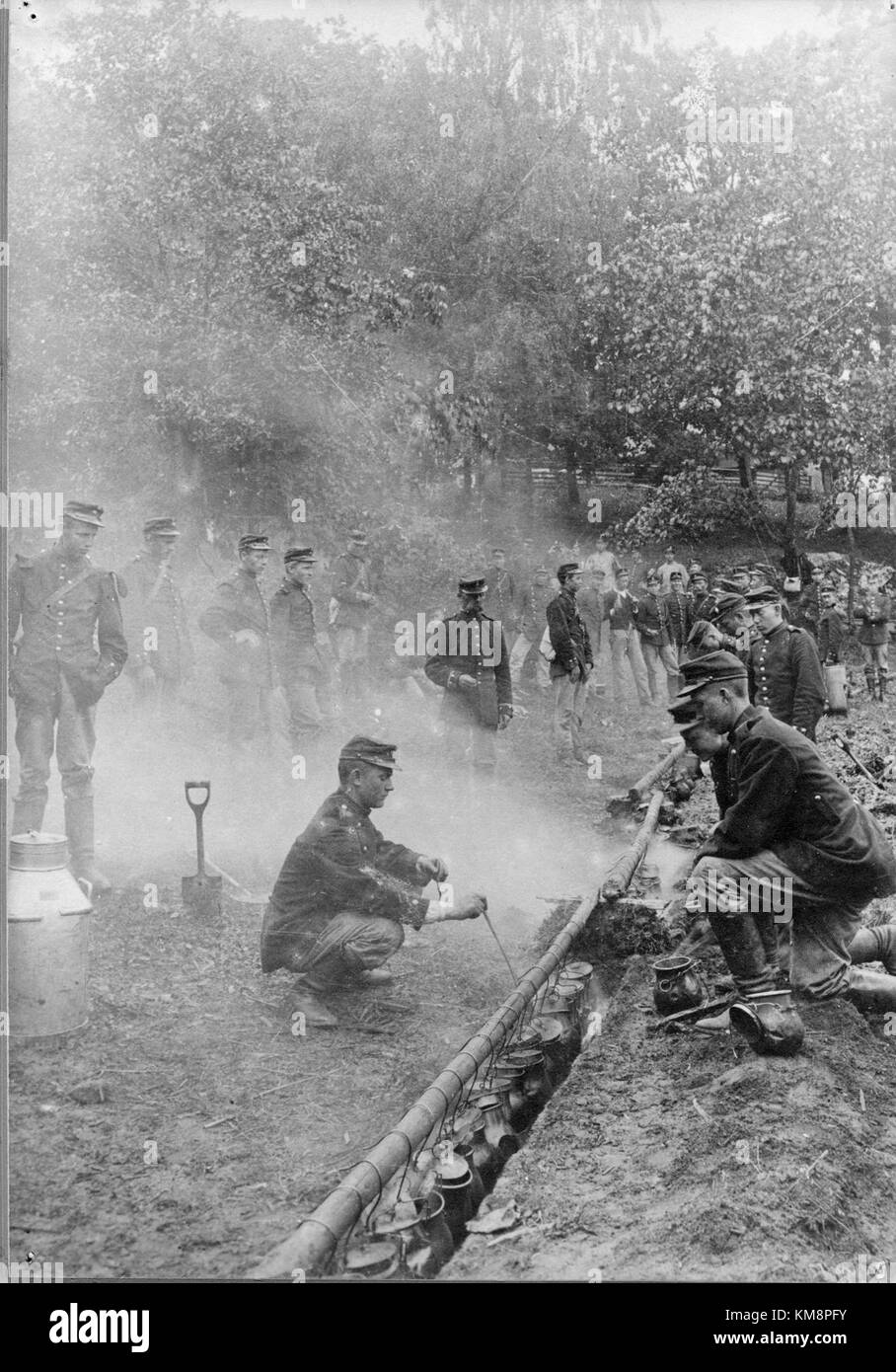 This image depicts the traditional method of cooking in a pit oven ...