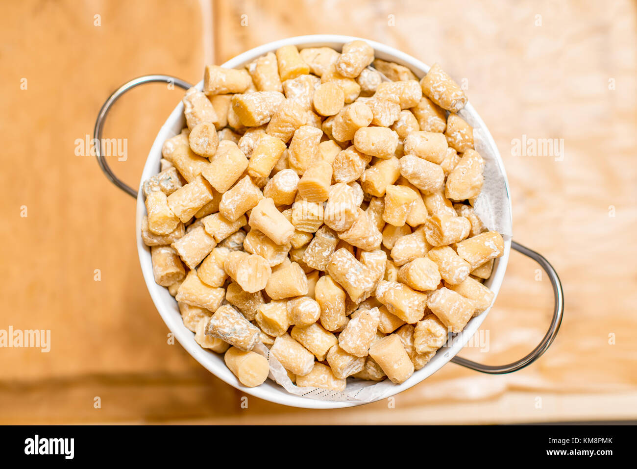 Top view on the bucket full of small seasoned cheeses Stock Photo - Alamy