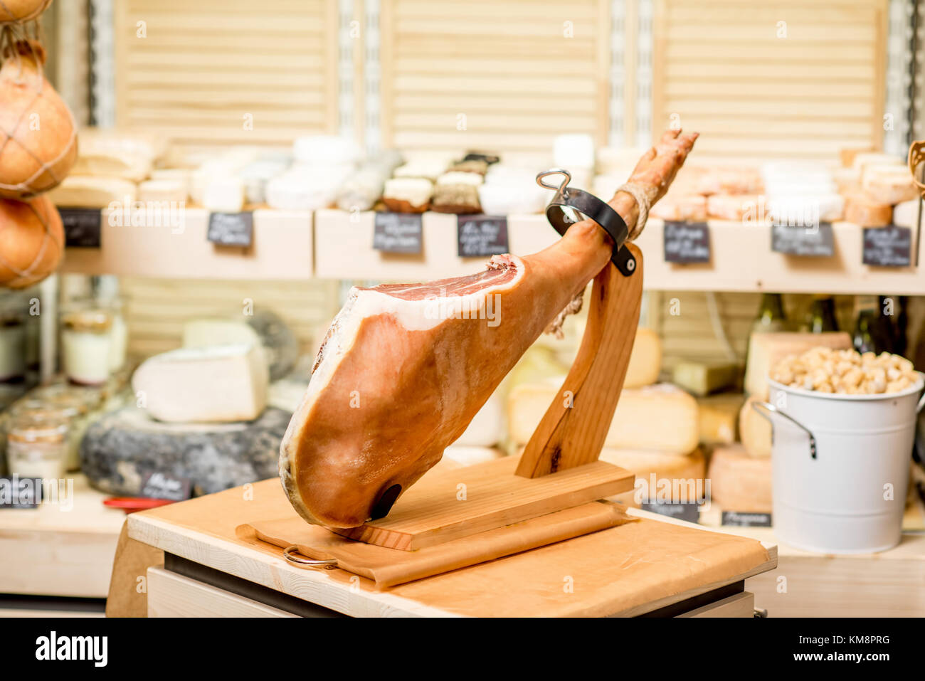 Prosciutto leg in ham holder on the table in the food store Stock Photo ...
