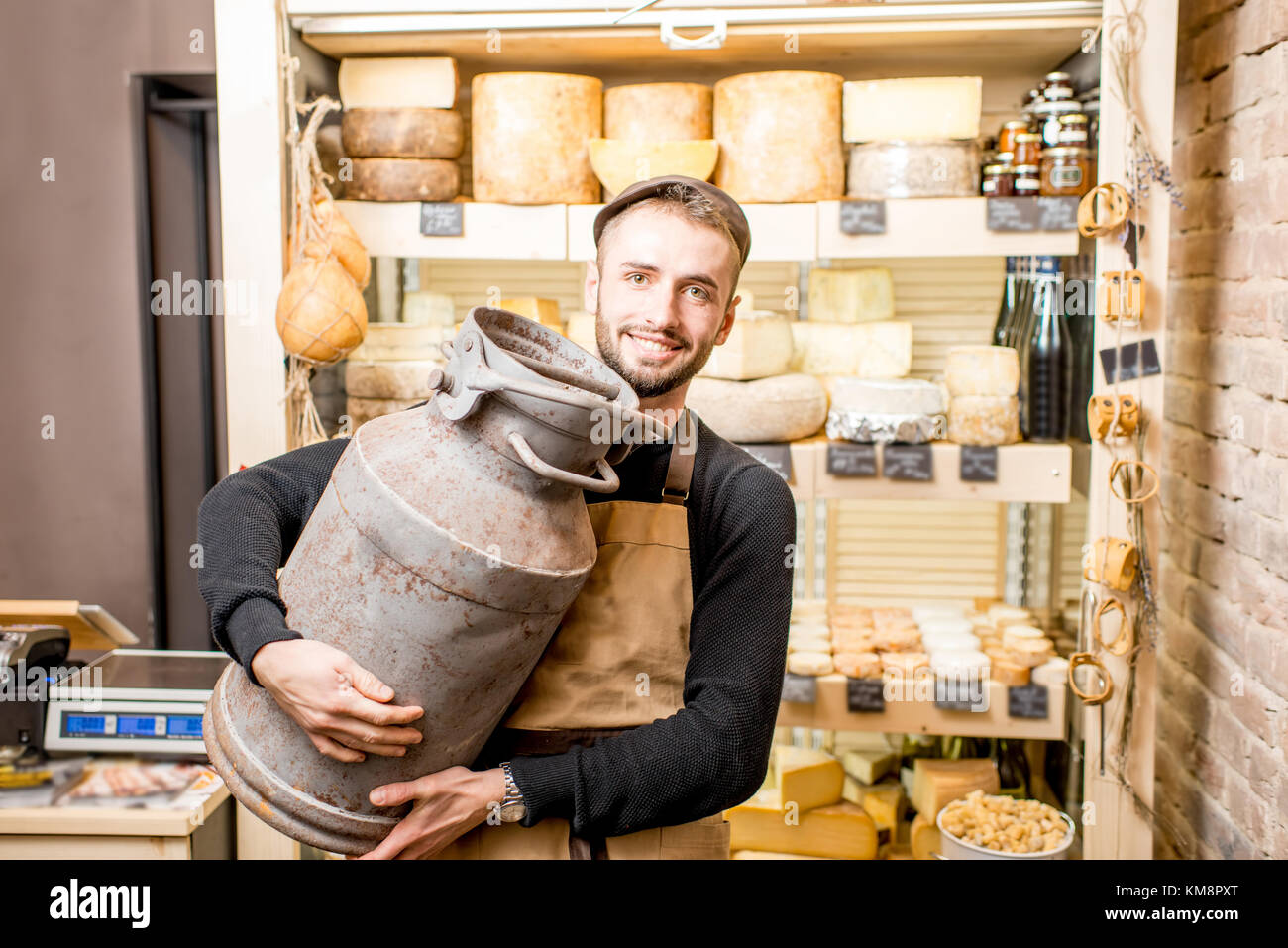 Portrait of a cheese seller with big dairy bucket standing in the ...