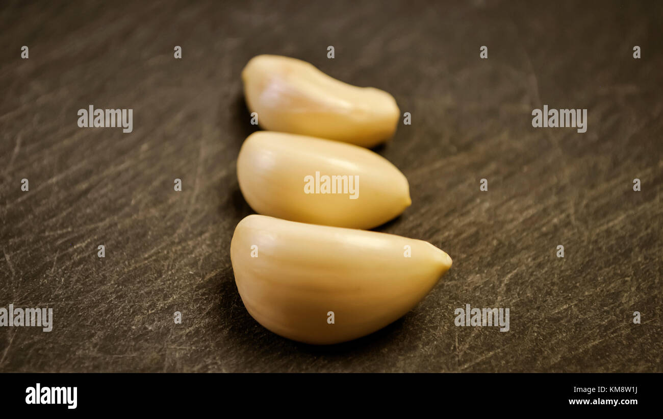 A composition of cloves of garlic on the table. Healthy eating Stock ...