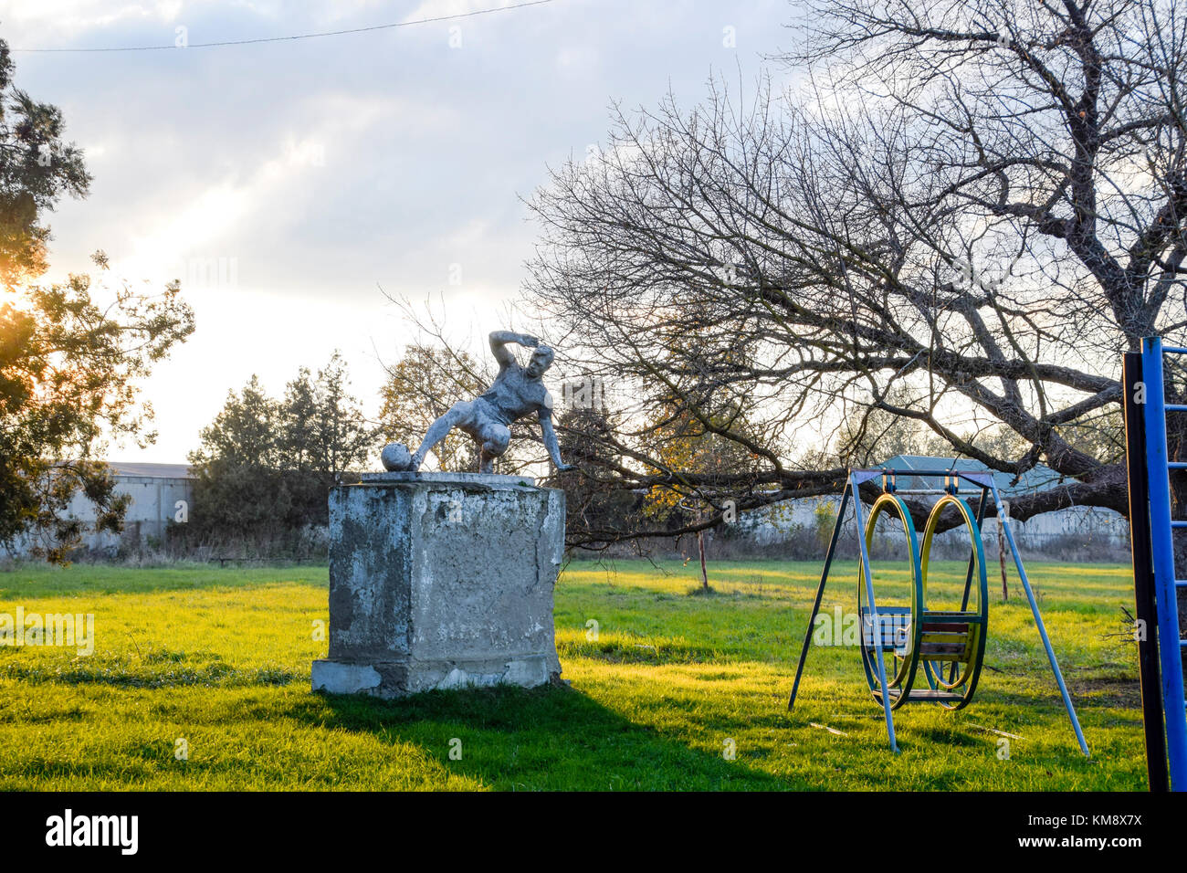Monument to the football player at the stadium. Children playground ...