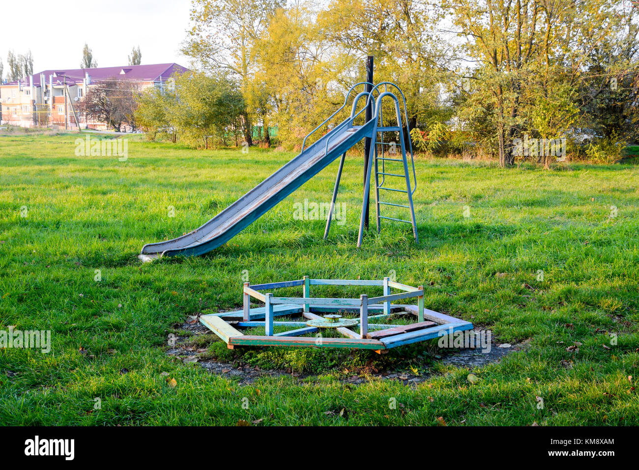 Children playground. Swings and a slide to slide Stock Photo - Alamy