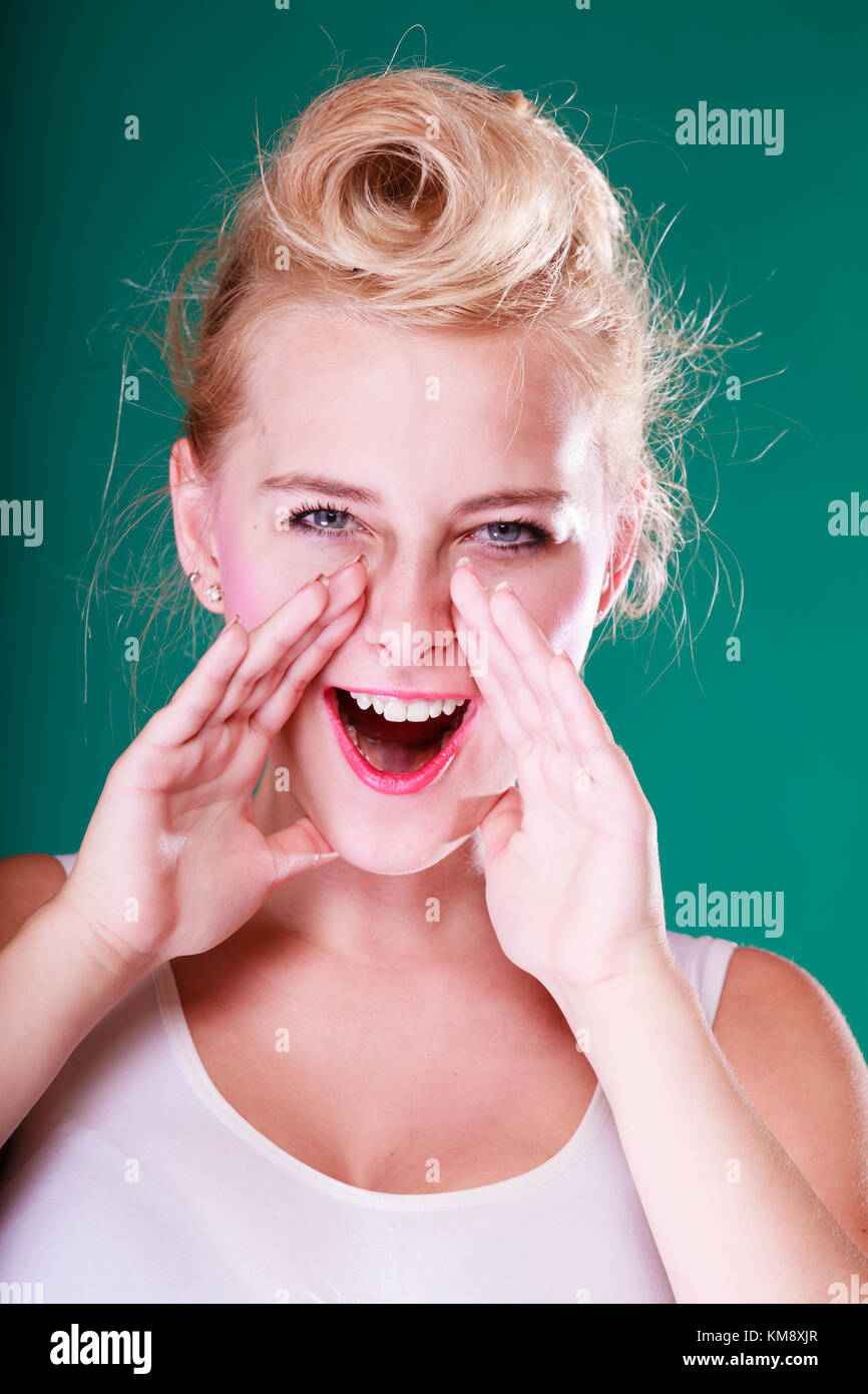 Yelling gestures concept. Lovely pin up girl screaming with hands close ...
