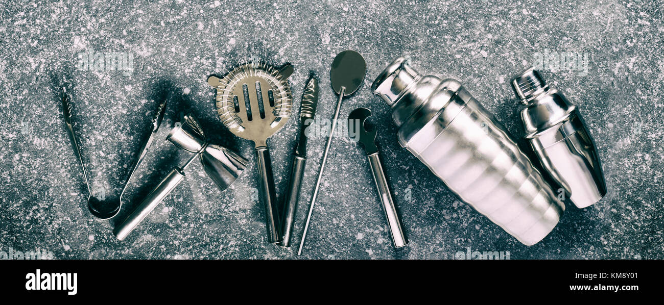Set of bar tools for making a cocktails arranged on a stone background ...
