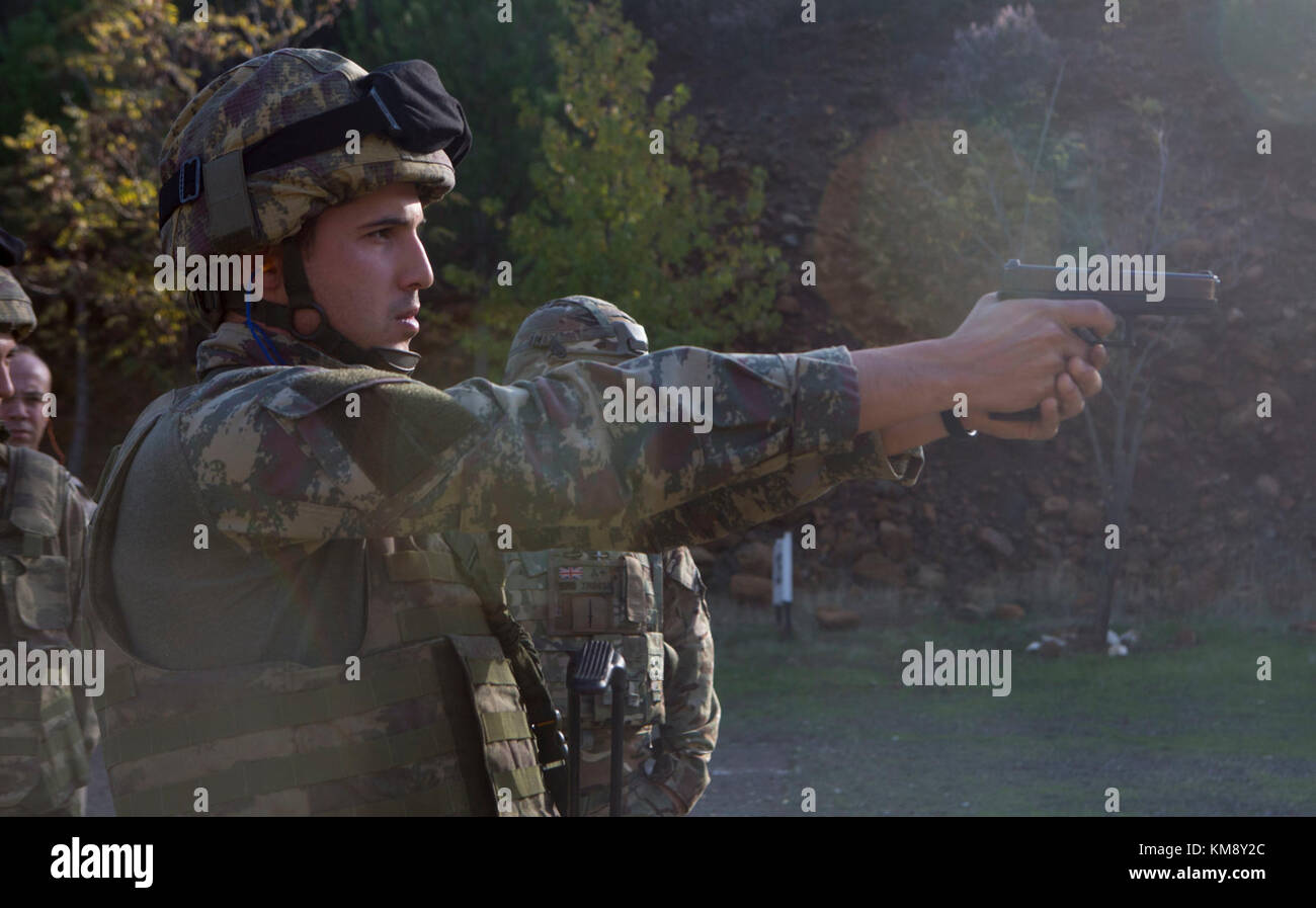 A Turkish Marine fires the British Royal Marines’ 9mm Glock pistol on a ...