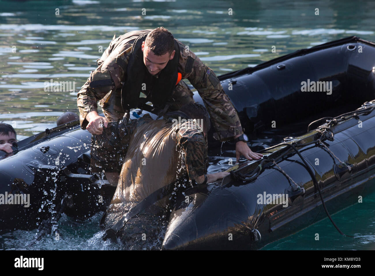 a royal british marine assists a u.s. marine with black sea rotational ...
