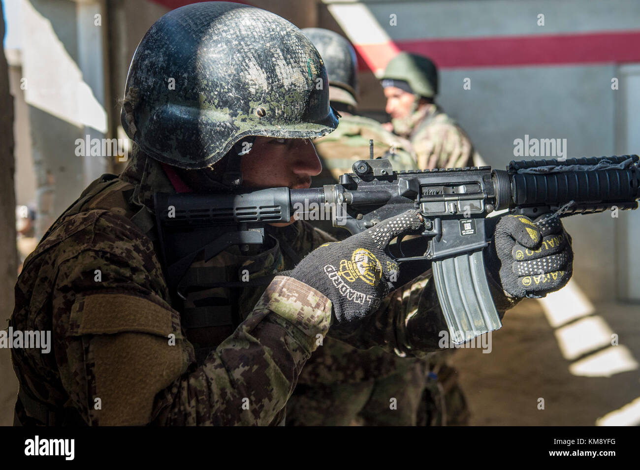 an afghan commando trainee provides security for his team during urban ...