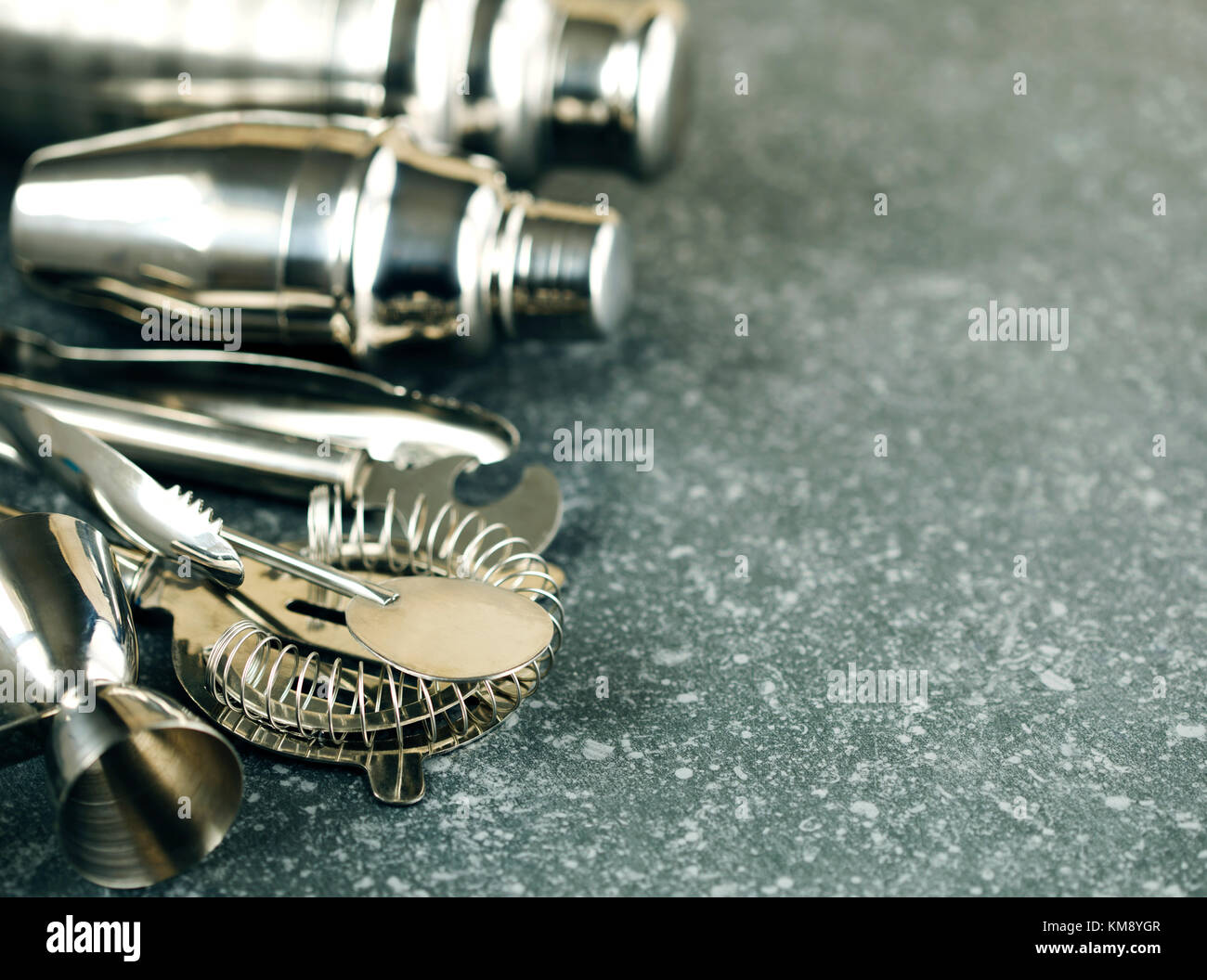 Set of bar tools for making a cocktails arranged on a stone background ...