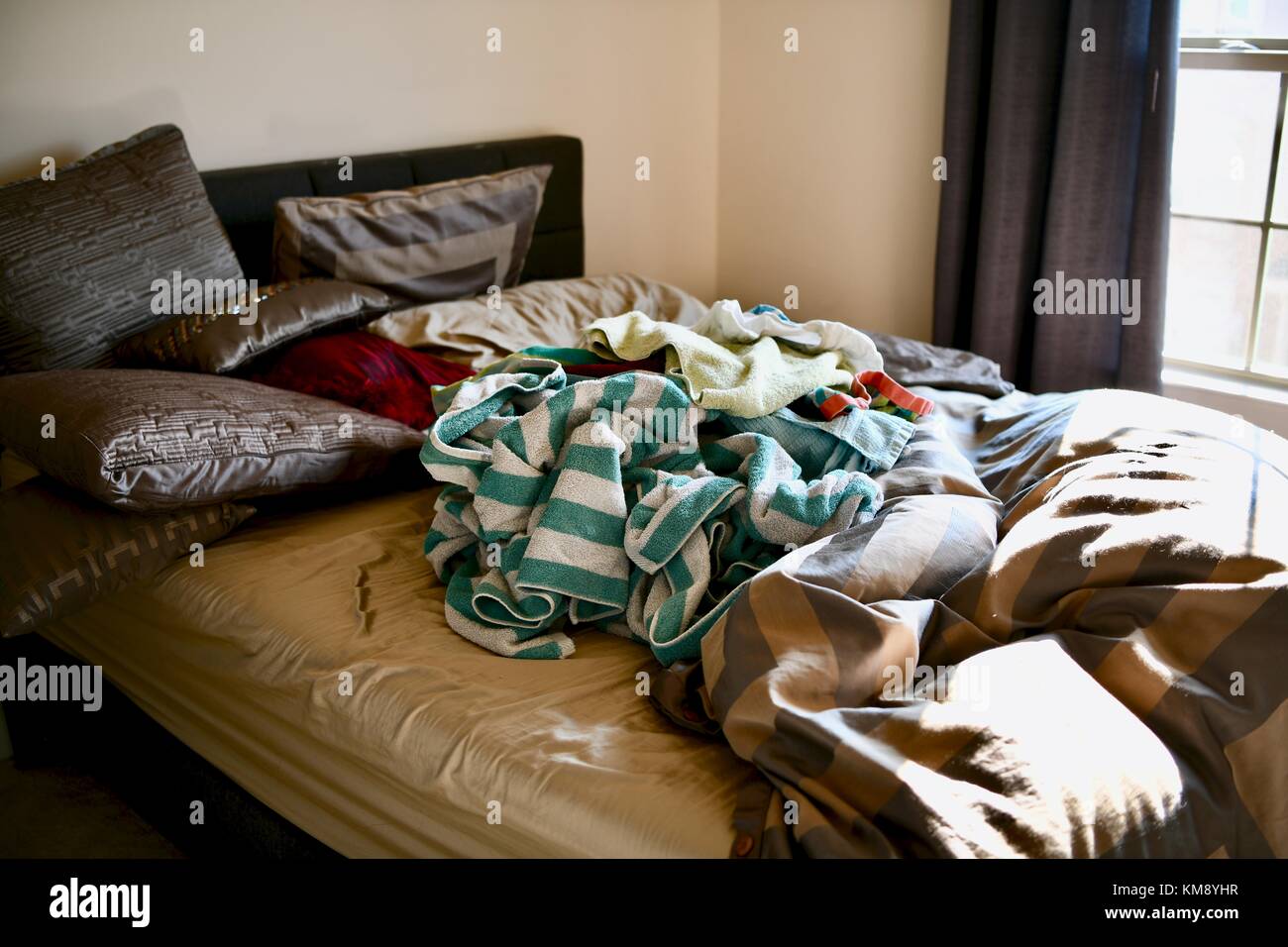 Laundry piled on bed hi-res stock photography and images - Alamy