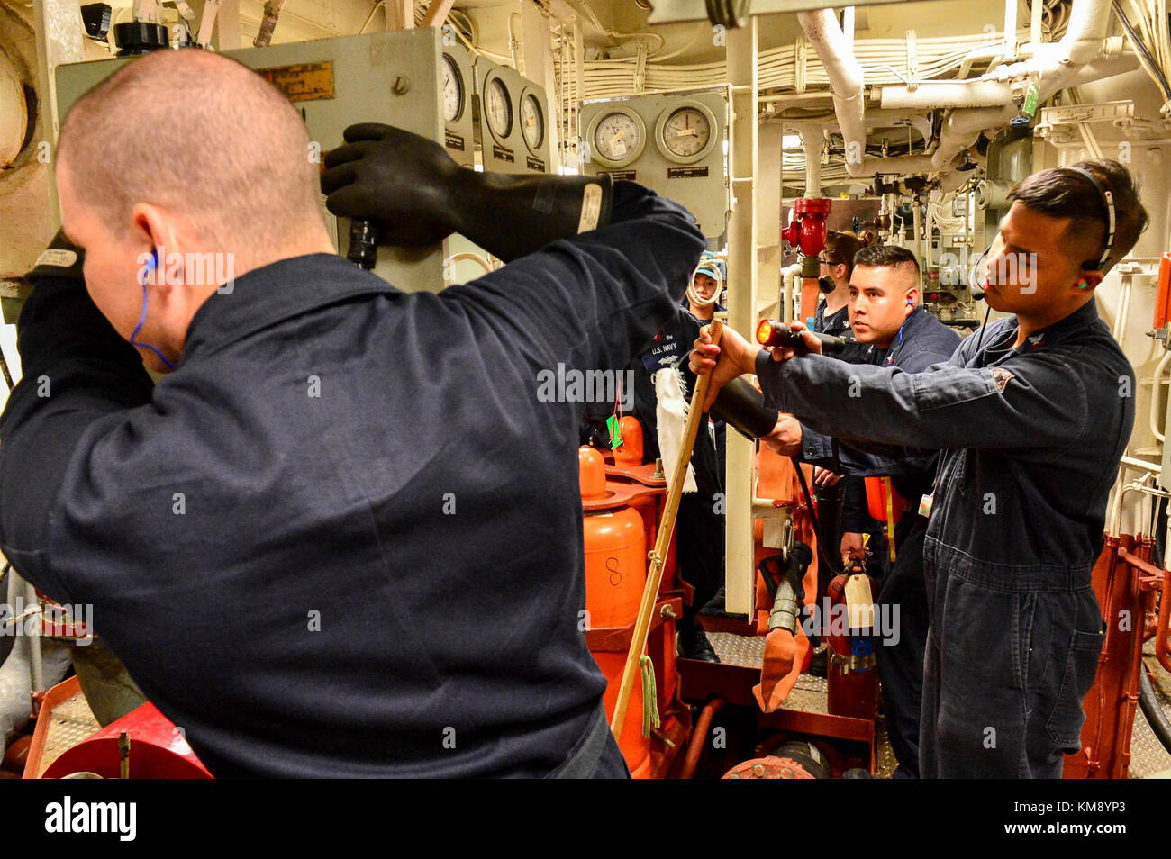 Electrician's Mate Fireman Ethan Silva, left, opens an electrical panel ...