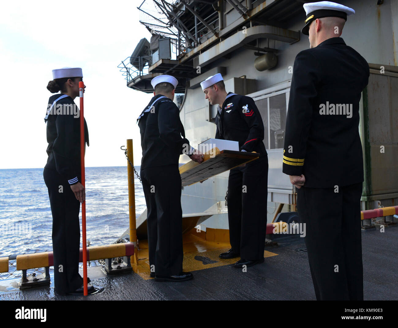 Sailors commit service members’ cremains during a burial-at -sea ...