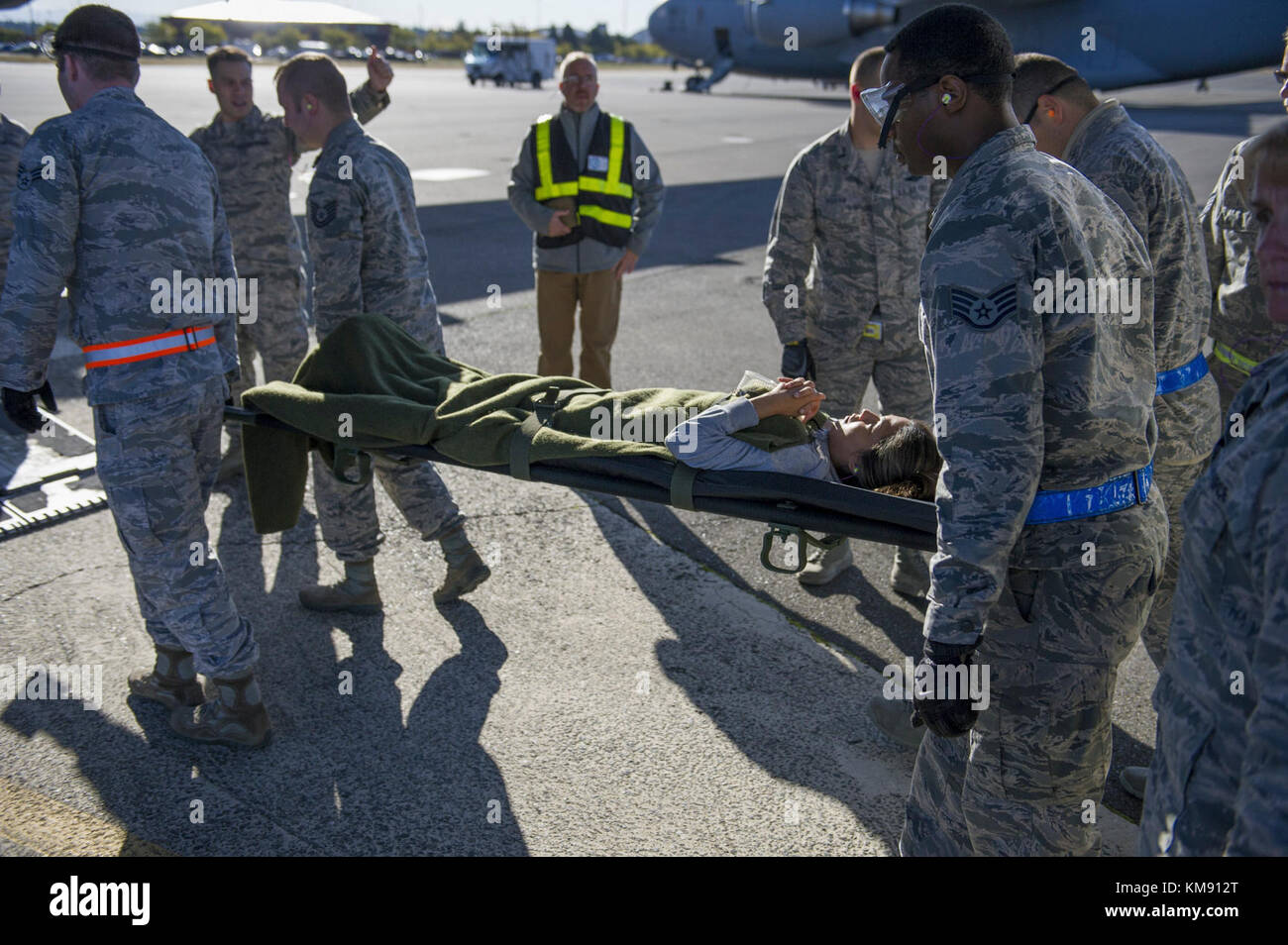 Airmen from the 446th Aeromedical Staging Squadron, carry a litter with ...