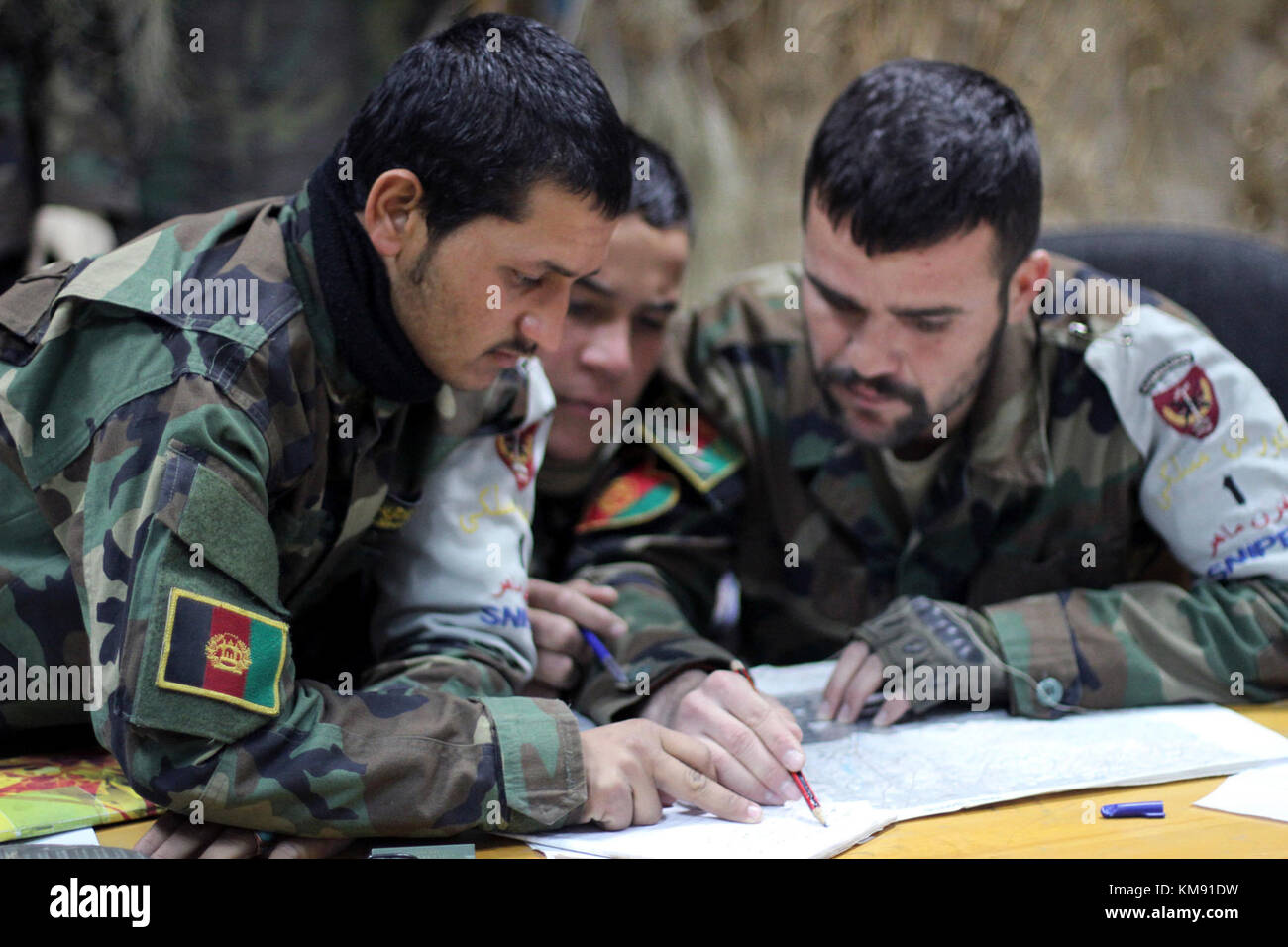 Afghan Commandos conduct a map reconnaissance to build their sniper ...