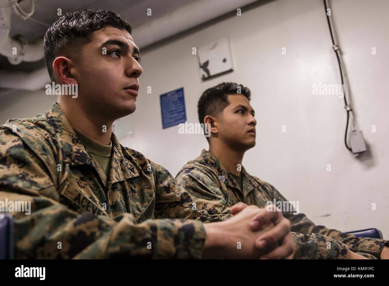 U.S. Marine Corps Lance Cpl. Cesar Acevedo, left, a radio operator with ...